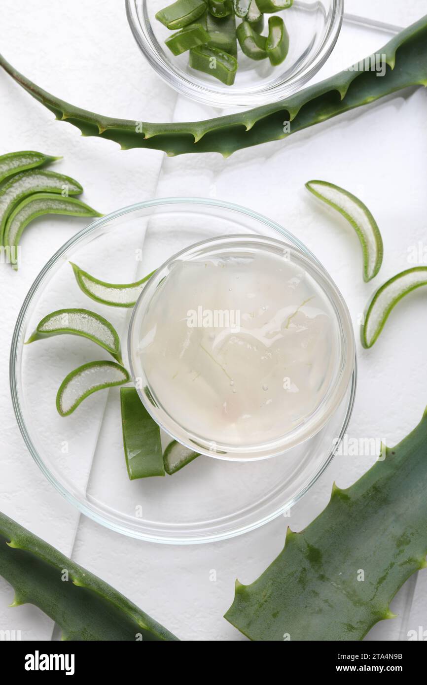 Aloe vera gel and slices of plant on white background, flat lay Stock ...