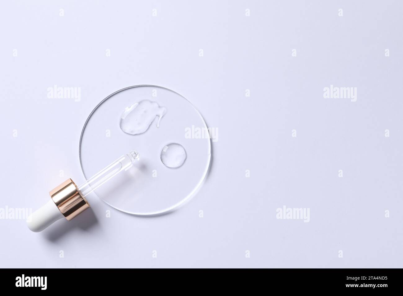 Samples of cosmetic serum and pipette on white background, top view ...