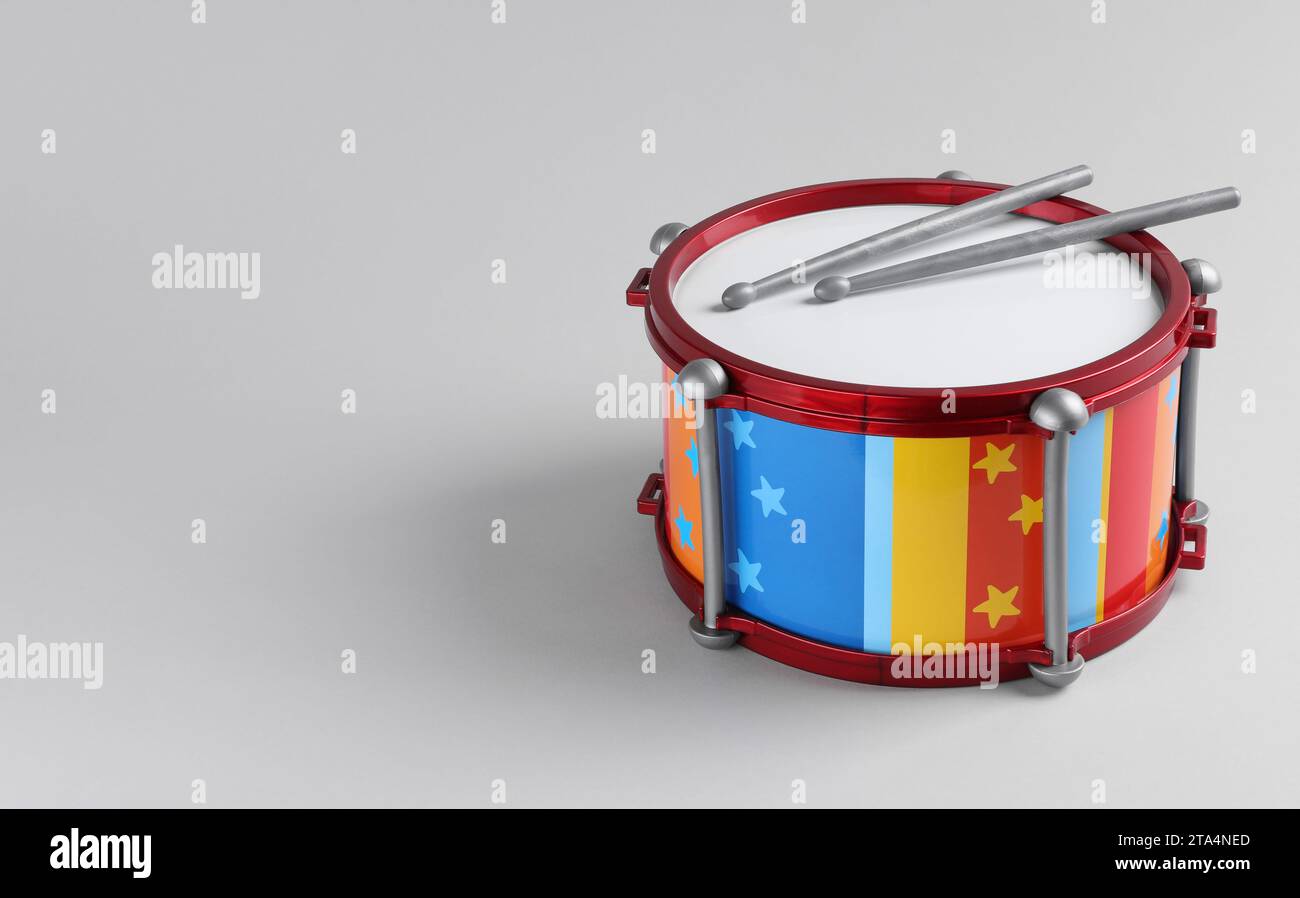 Colorful drum and sticks on light background. Percussion musical ...