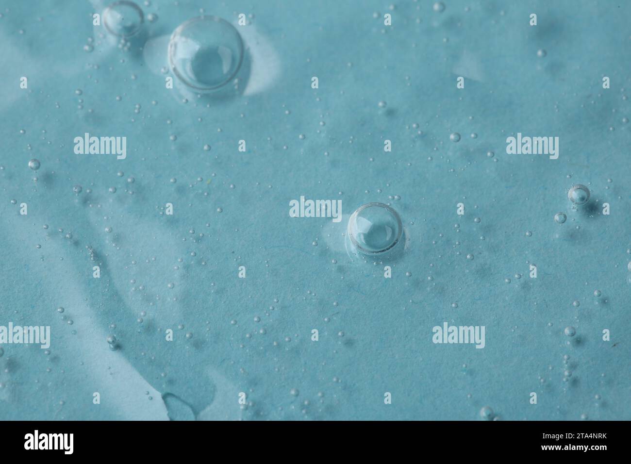 Cosmetic serum on light blue background, above view Stock Photo - Alamy