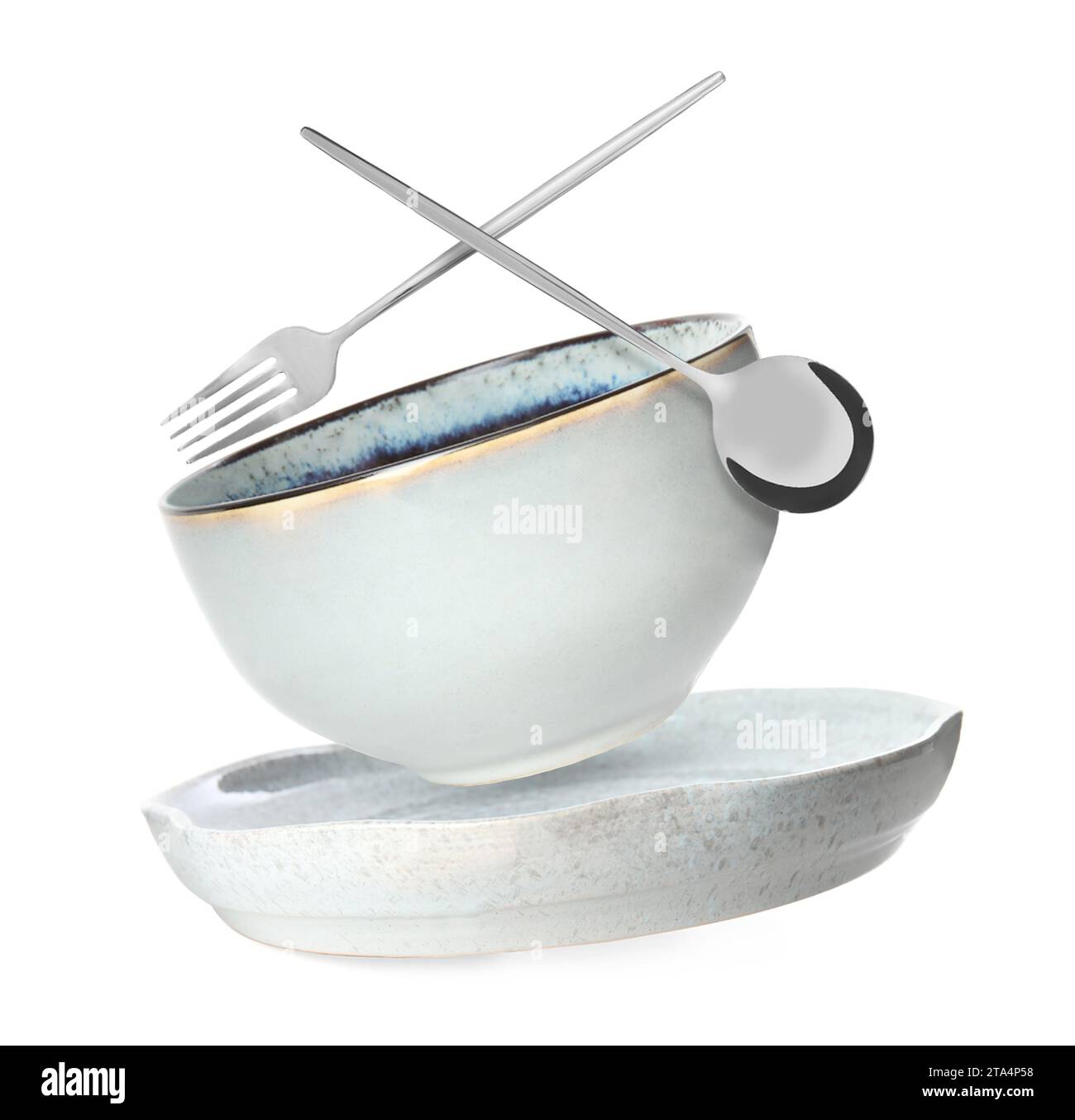 Clean dishes, fork and spoon falling on white background Stock Photo ...