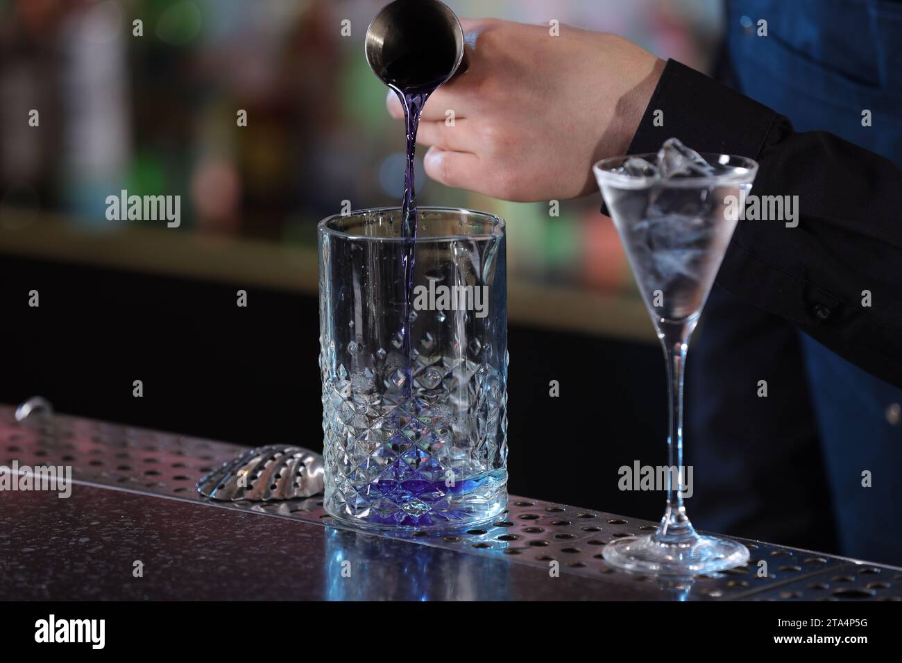Bartender making fresh alcoholic cocktail at bar counter, closeup Stock ...