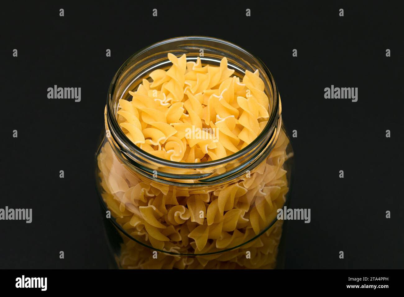 Uncooked Fusilli Pasta in Glass Jar on Black Background. Raw and Dry ...