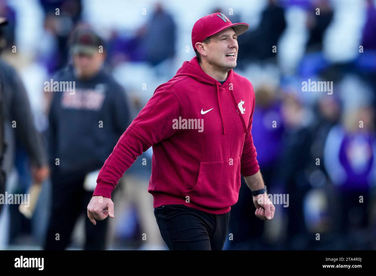 Washington State head coach Jake Dickert walks on the field before an ...