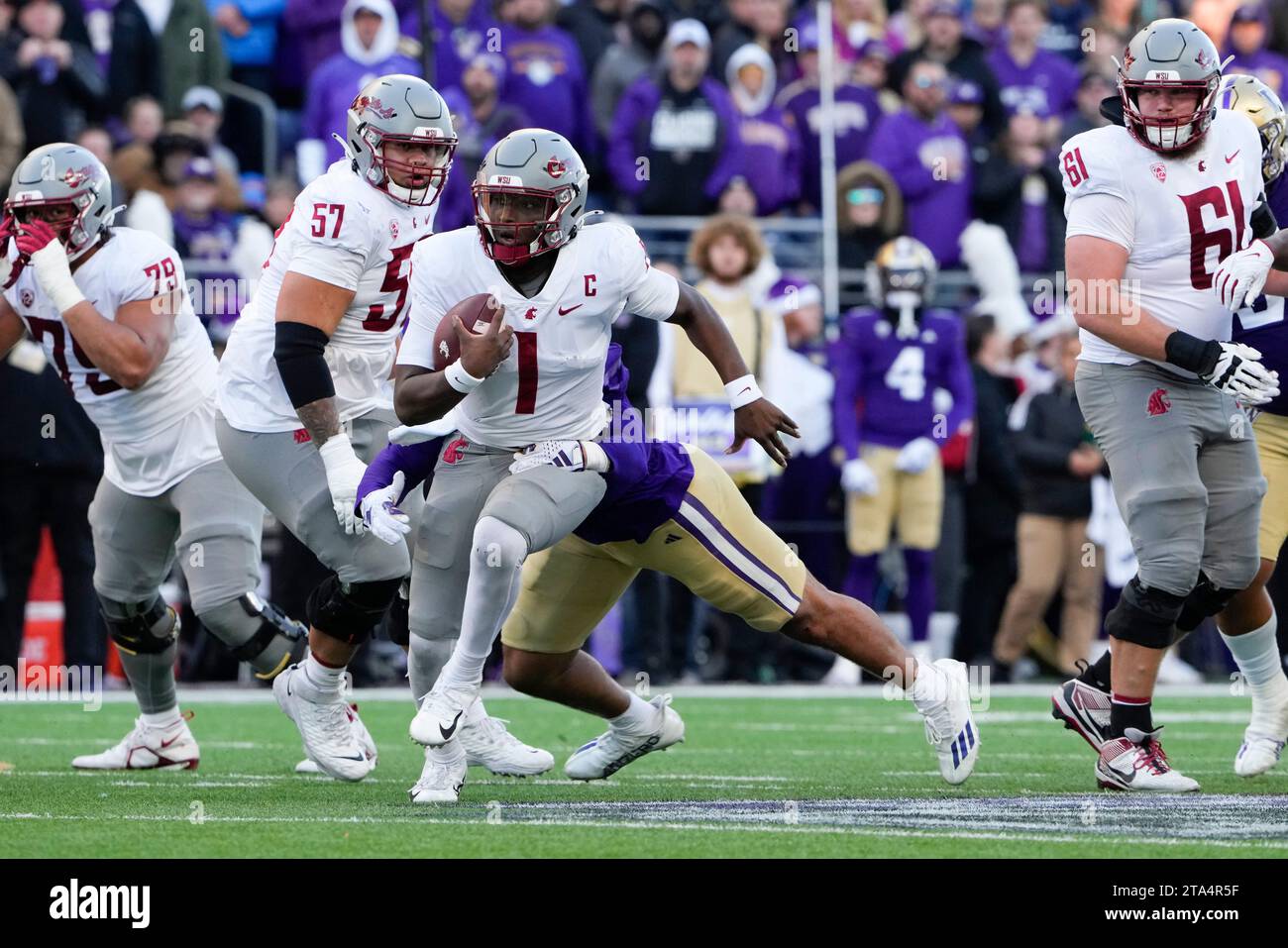 Washington State quarterback Cameron Ward (1) is tackled by Washington ...