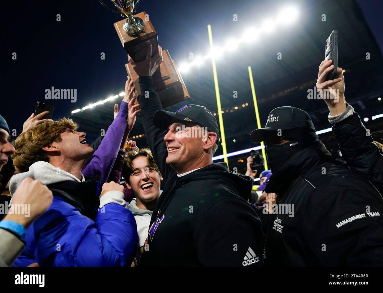 Washington head coach Kalen DeBoer holds the Apple Cup trophy after a ...