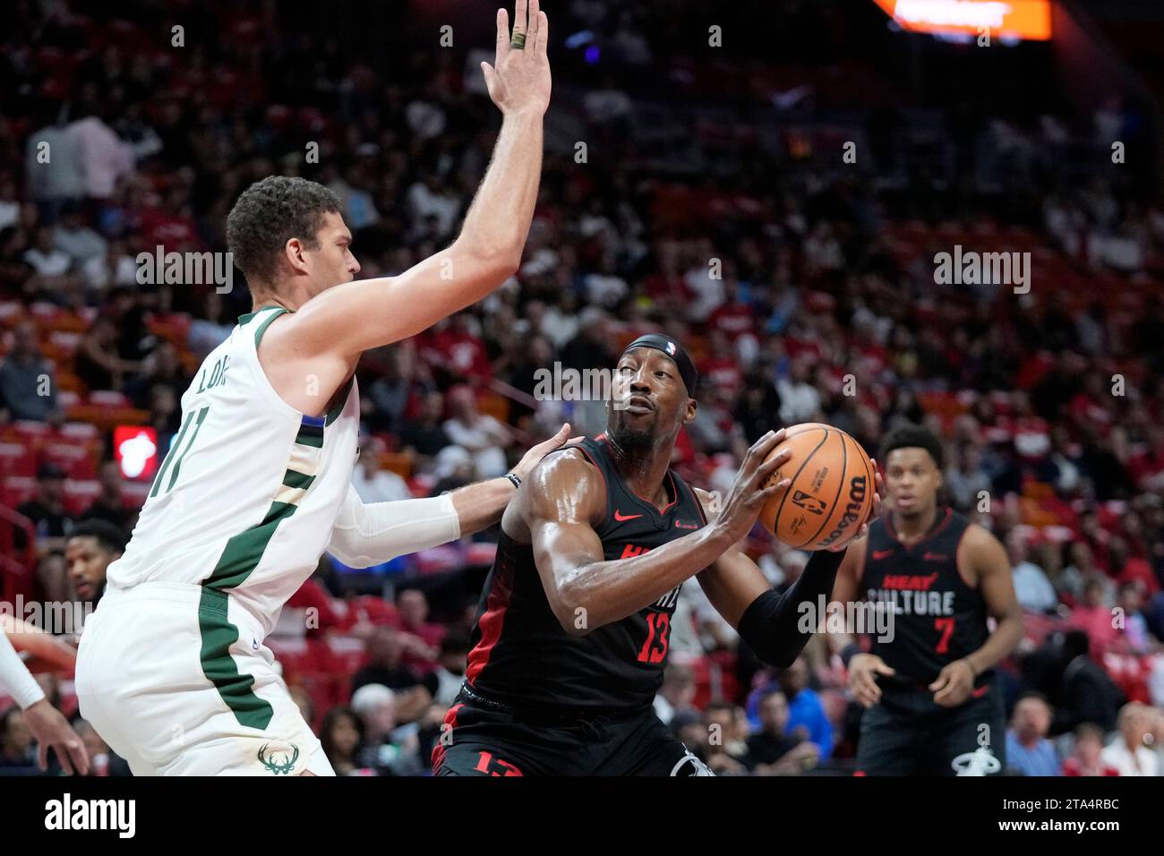 Miami Heat center Bam Adebayo (13) looks for an opening past Milwaukee ...