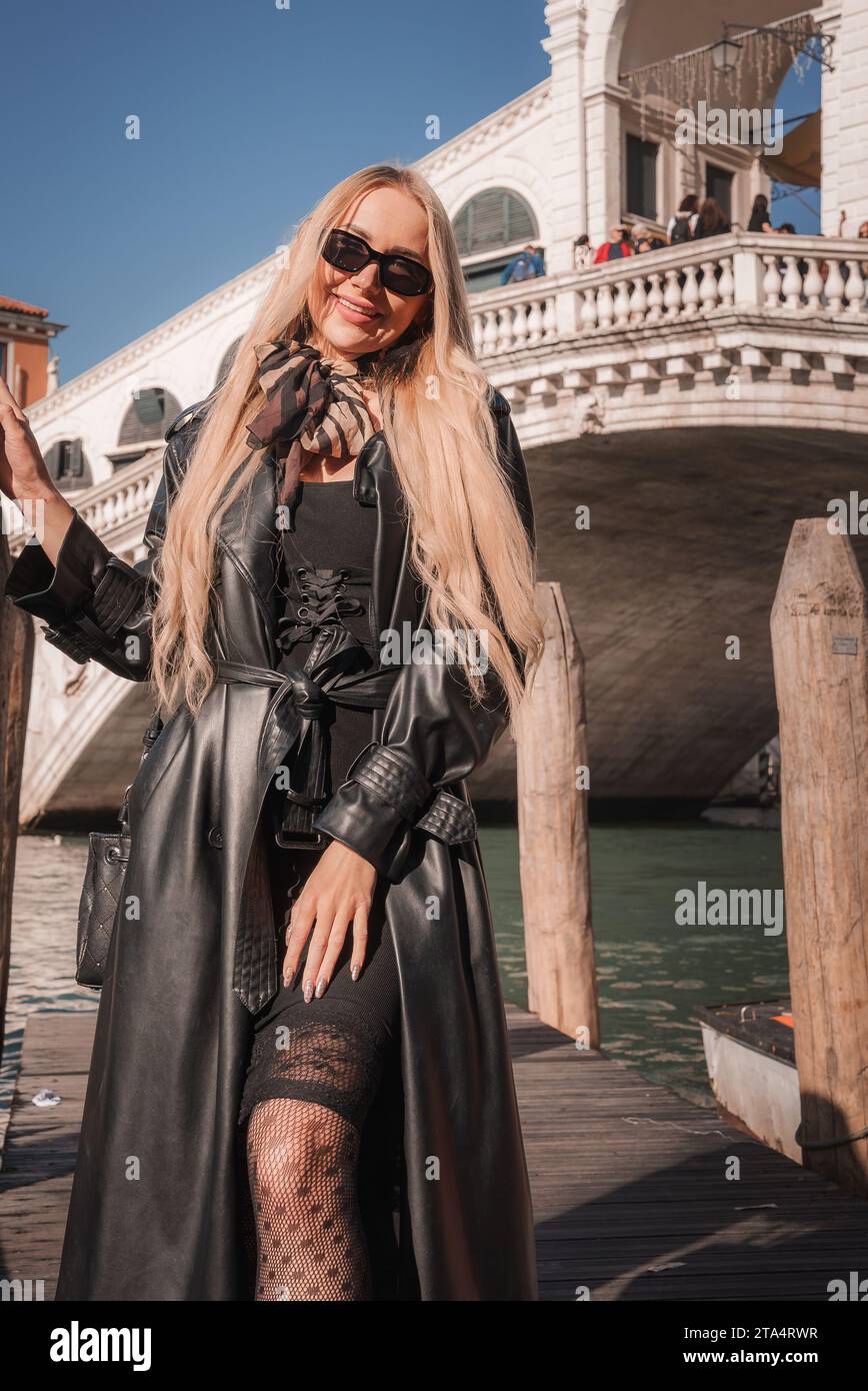 Stylish Woman in Leather Trench Coat Poses on Iconic Venice Bridge in ...