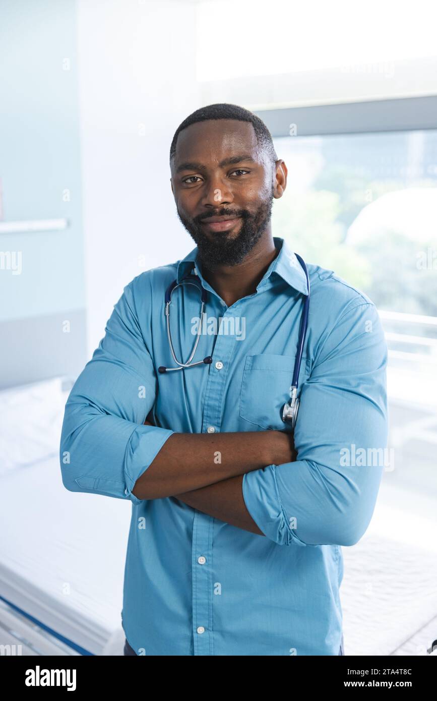 Portrait of happy african american male doctor wearing blue shirt and ...