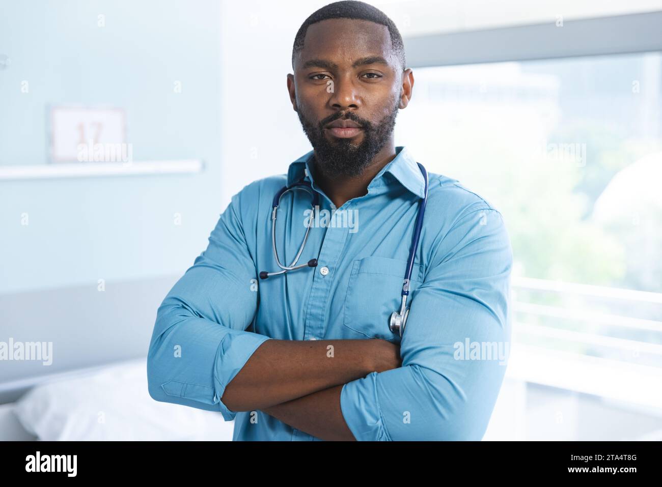 Portrait of happy african american male doctor wearing blue shirt and ...