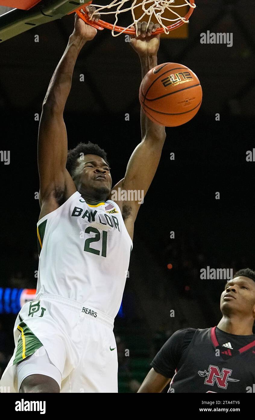 Baylor center Yves Missi (21) slam dunks against Nicholls State forward ...