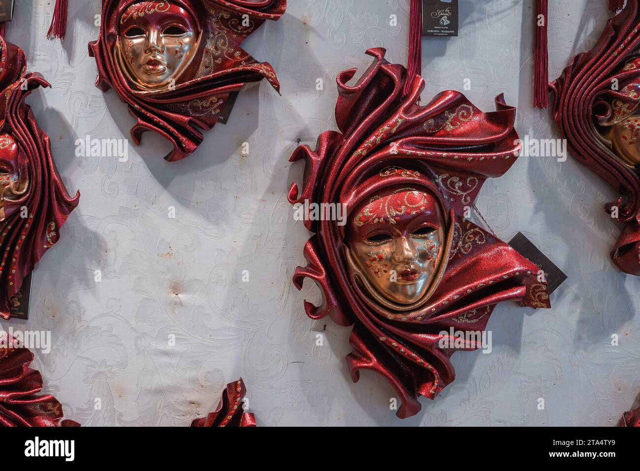 Collection of Red Venetian Masks Displayed in Dimly Lit Interior in ...