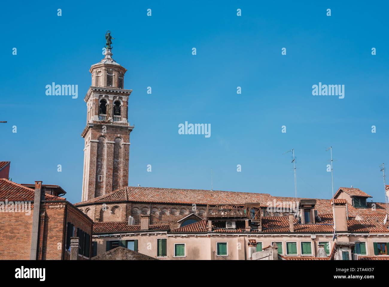 Clock tower on building in urban setting with unknown architectural ...