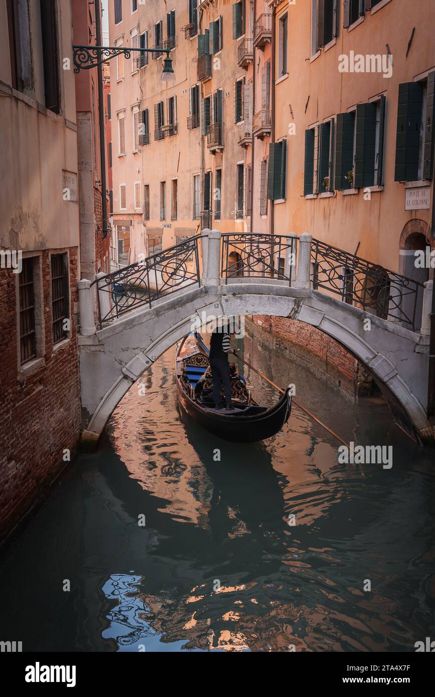 Tranquil gondola ride through modern Venice canal with tall buildings ...