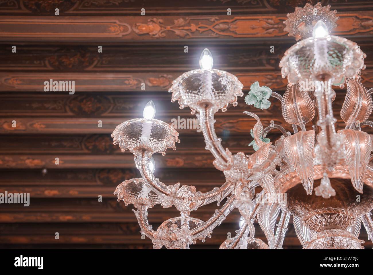 A stunning glass chandelier hangs in an unspecified room, creating an ...