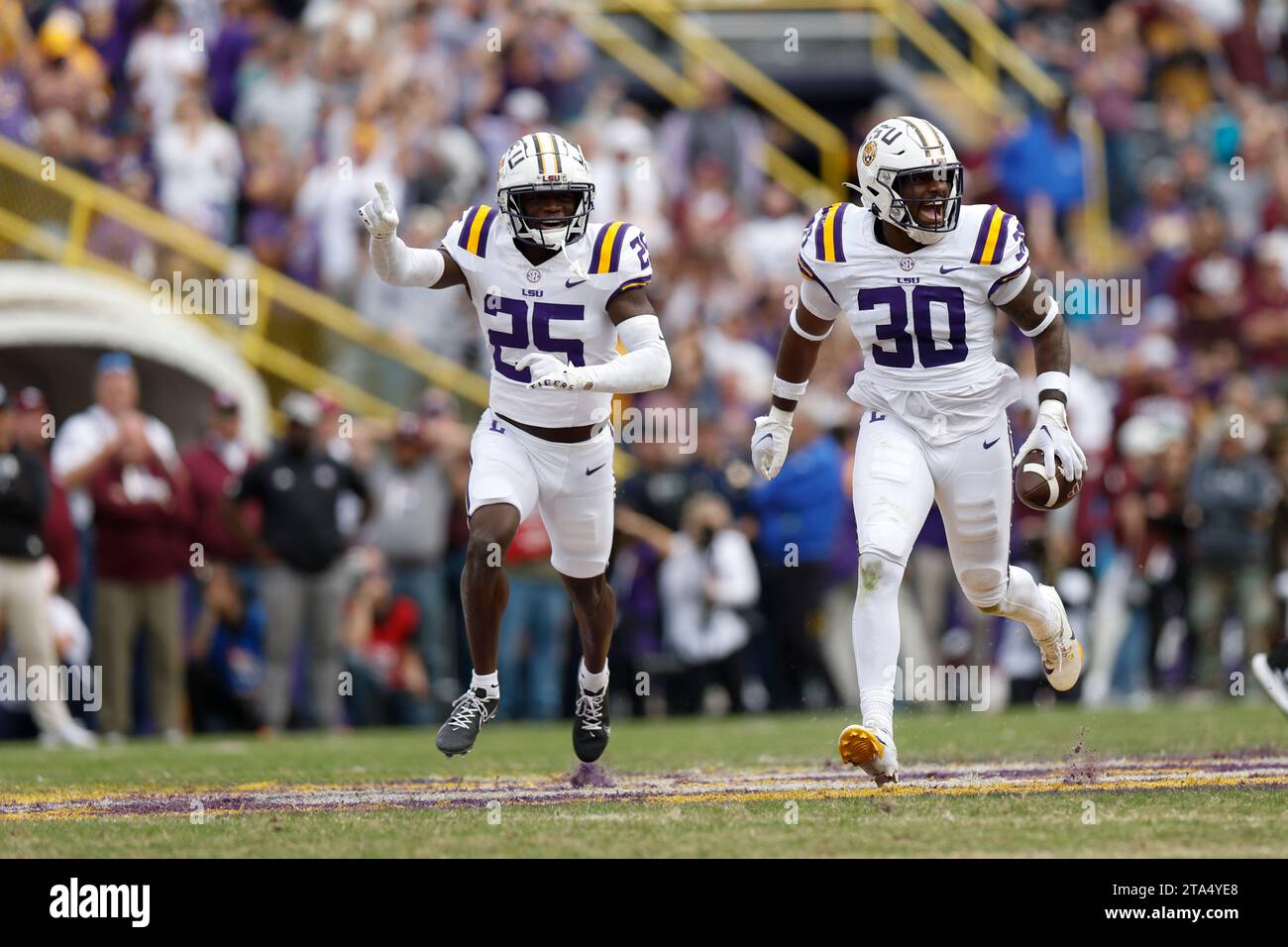 LSU linebacker Greg Penn III (30) and teammate Javien Toviano (25 ...