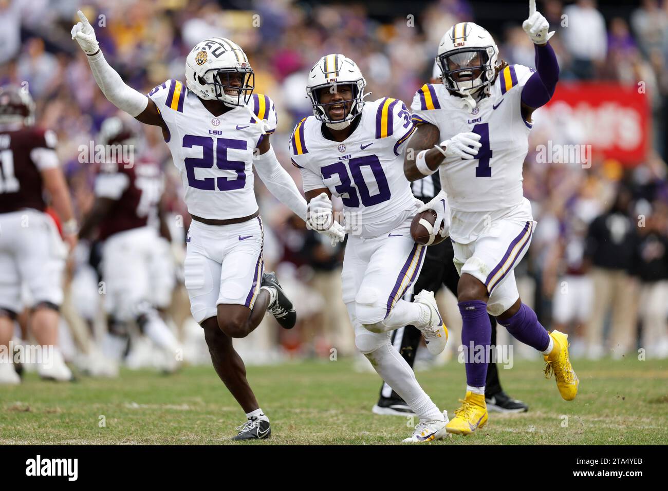 LSU linebacker Greg Penn III (30) and teammates Javien Toviano (25 ...