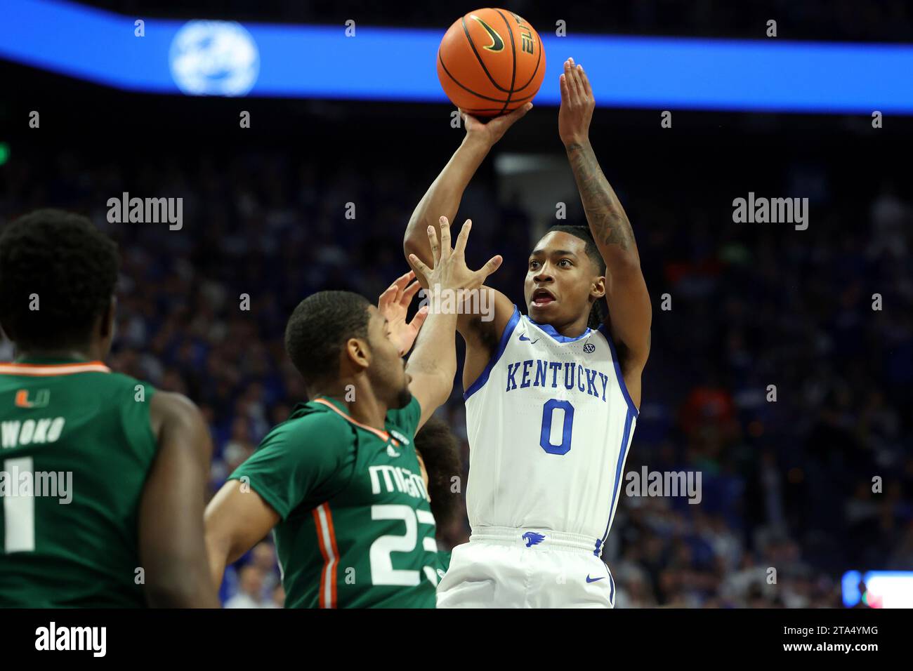 Kentucky's Rob Dillingham (0) shoots while defended by Miami's AJ Casey ...