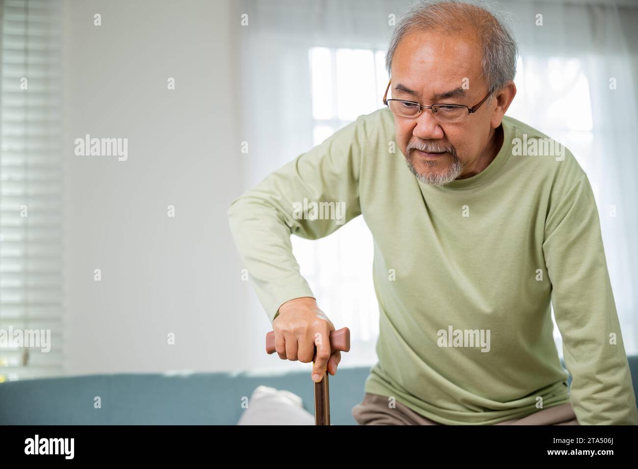 Elderly man suffering from knee pain ache holding handle of cane Stock ...