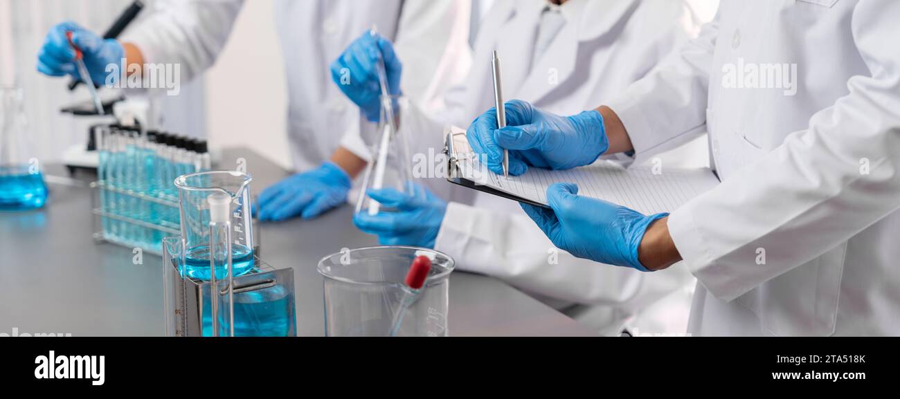 Group of dedicated scientist conduct chemical experiments and research in medical lab as ...