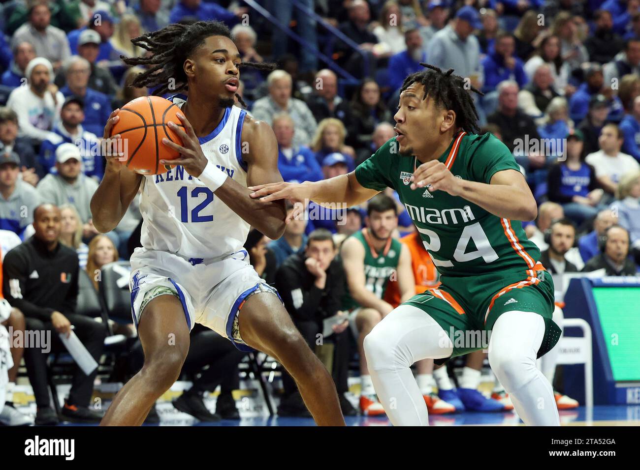 Kentucky's Antonio Reeves (12) looks for an opening on Miami's Nijel ...