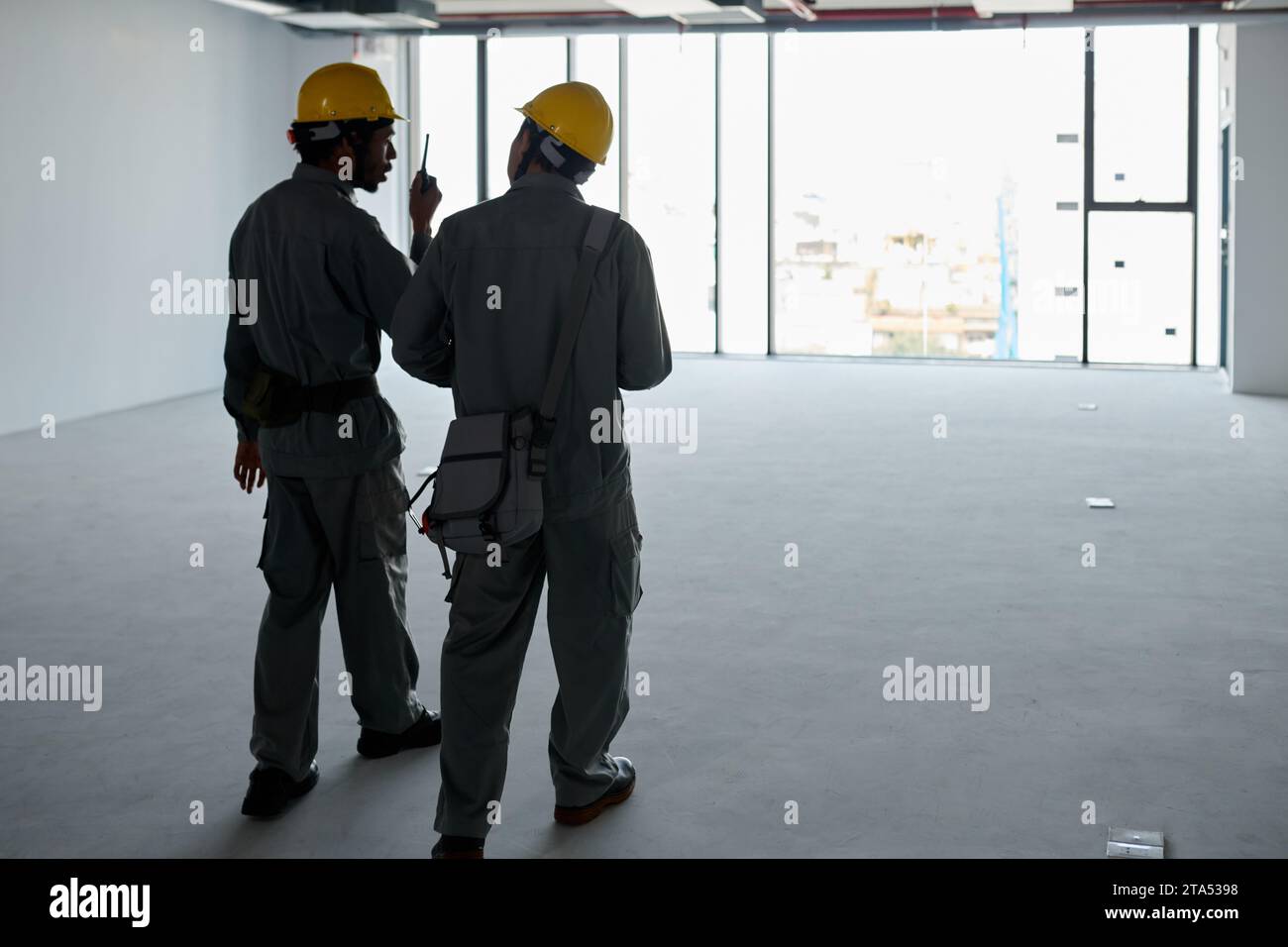 Foreman and contractor working in building under construction Stock ...