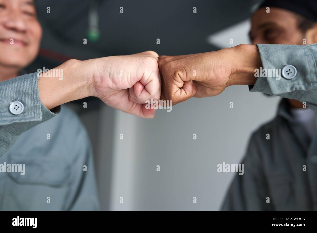 Builders giving each other fist bump after finishing shift at ...