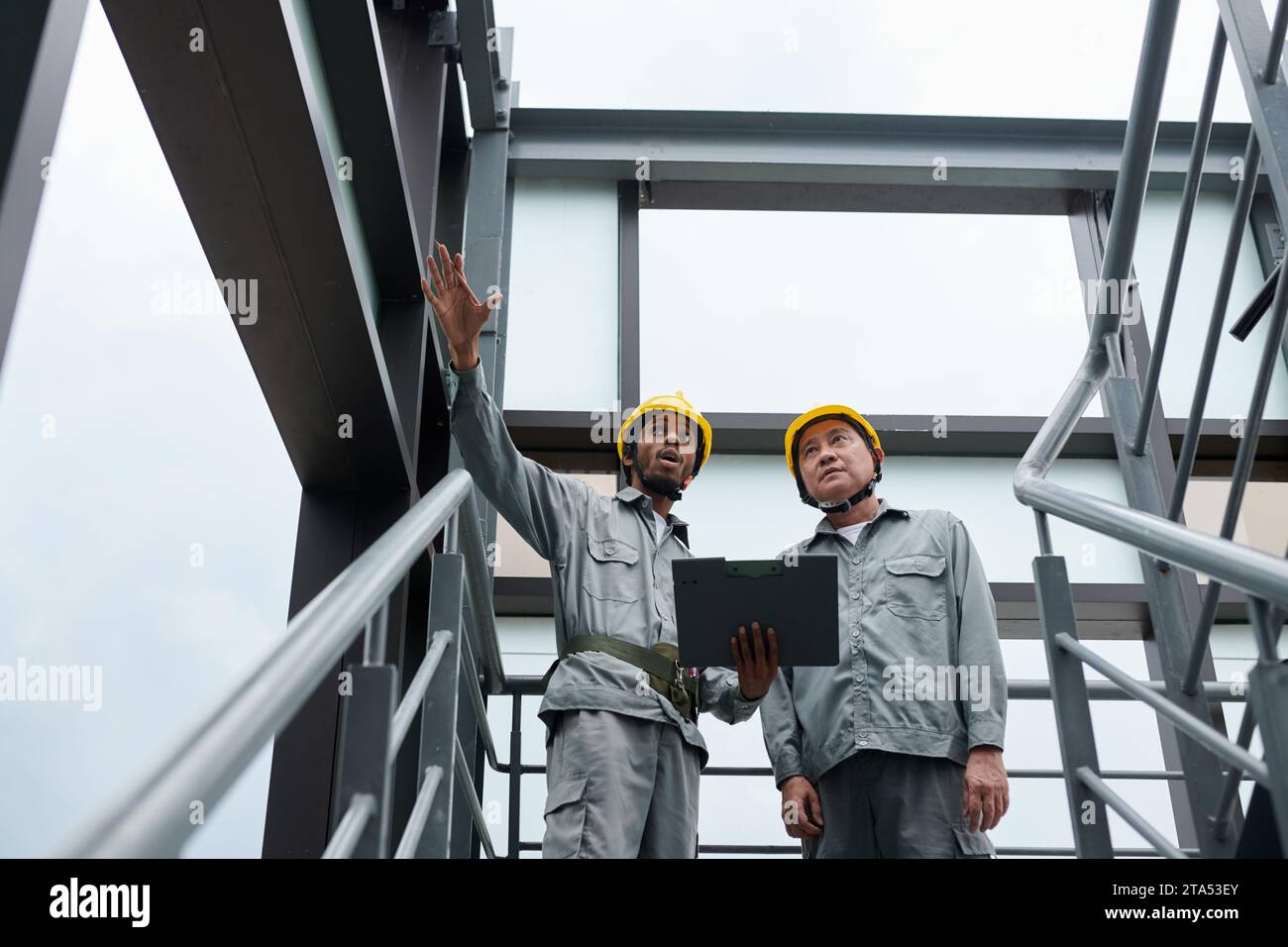 Foreman showing construction site to new contractor and explaining what ...