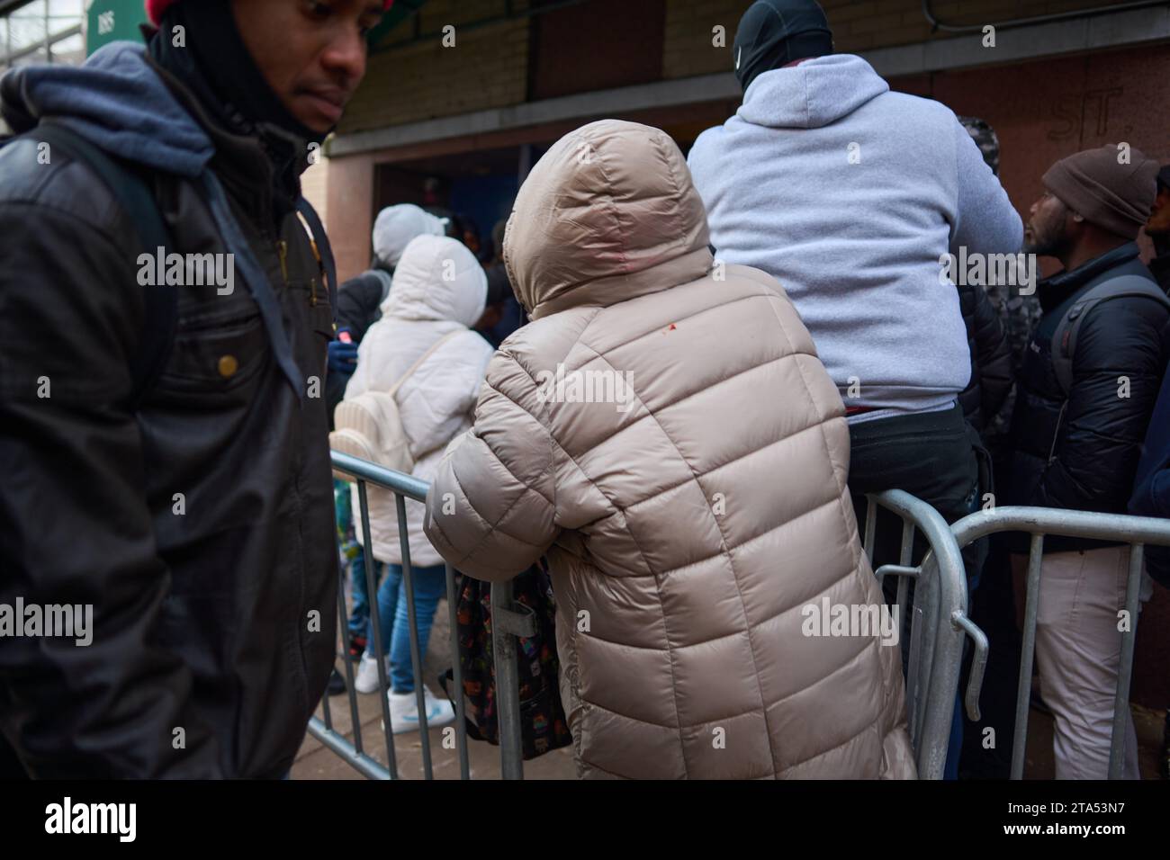 New York, New York, USA. 28th Nov, 2023. Migrants wait outside in the ...