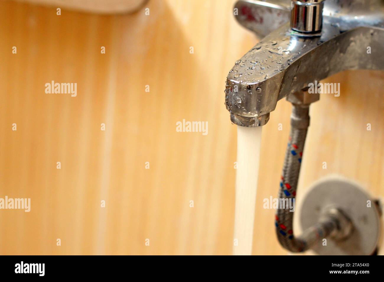water flowing through a handheld shower tap, a type of faucet that is ...