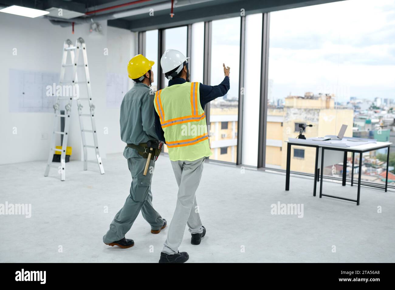Engineer and contractor discussing how to build room divider Stock ...