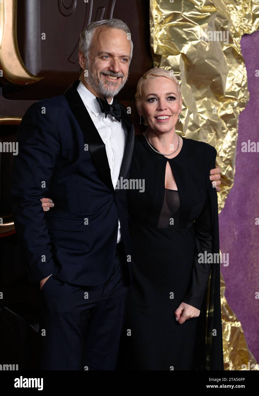 London, UK. 28th Nov, 2023. Ed Sinclair and Olivia Colman arriving at ...