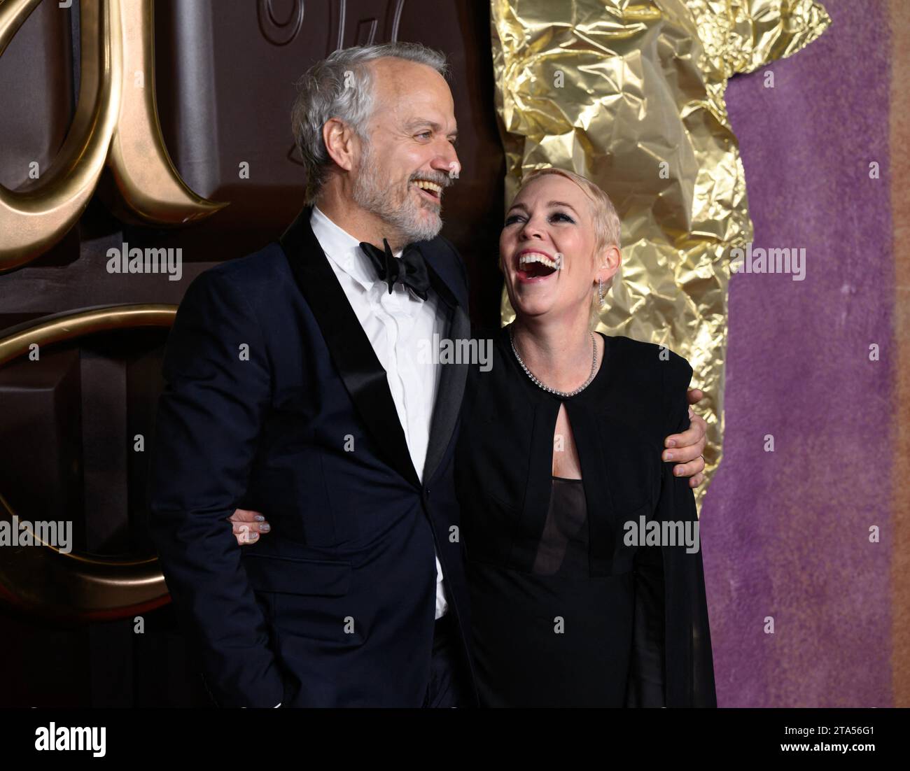 London, UK. 28th Nov, 2023. Ed Sinclair and Olivia Colman arriving at ...