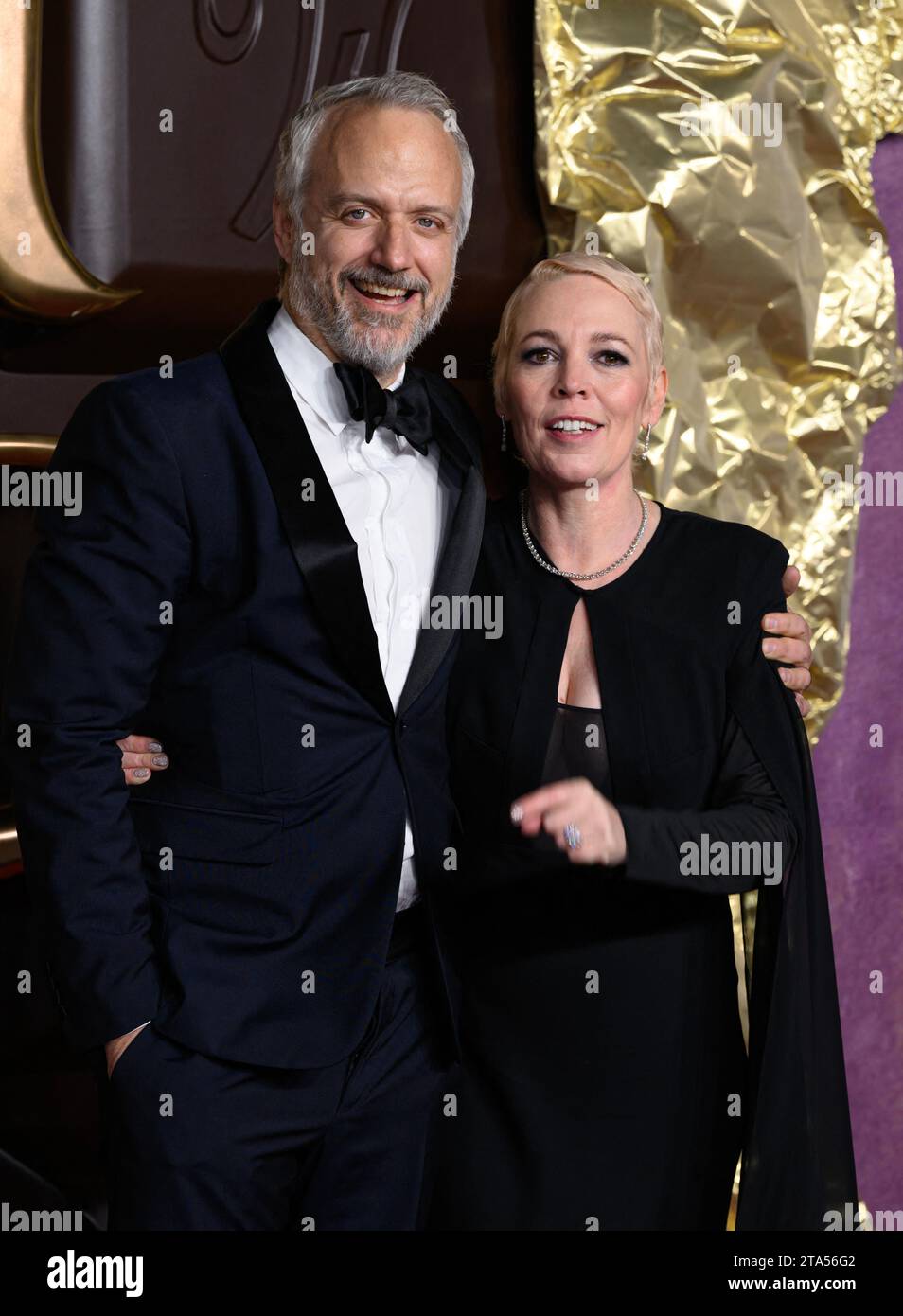 London, UK. 28th Nov, 2023. Ed Sinclair and Olivia Colman arriving at ...