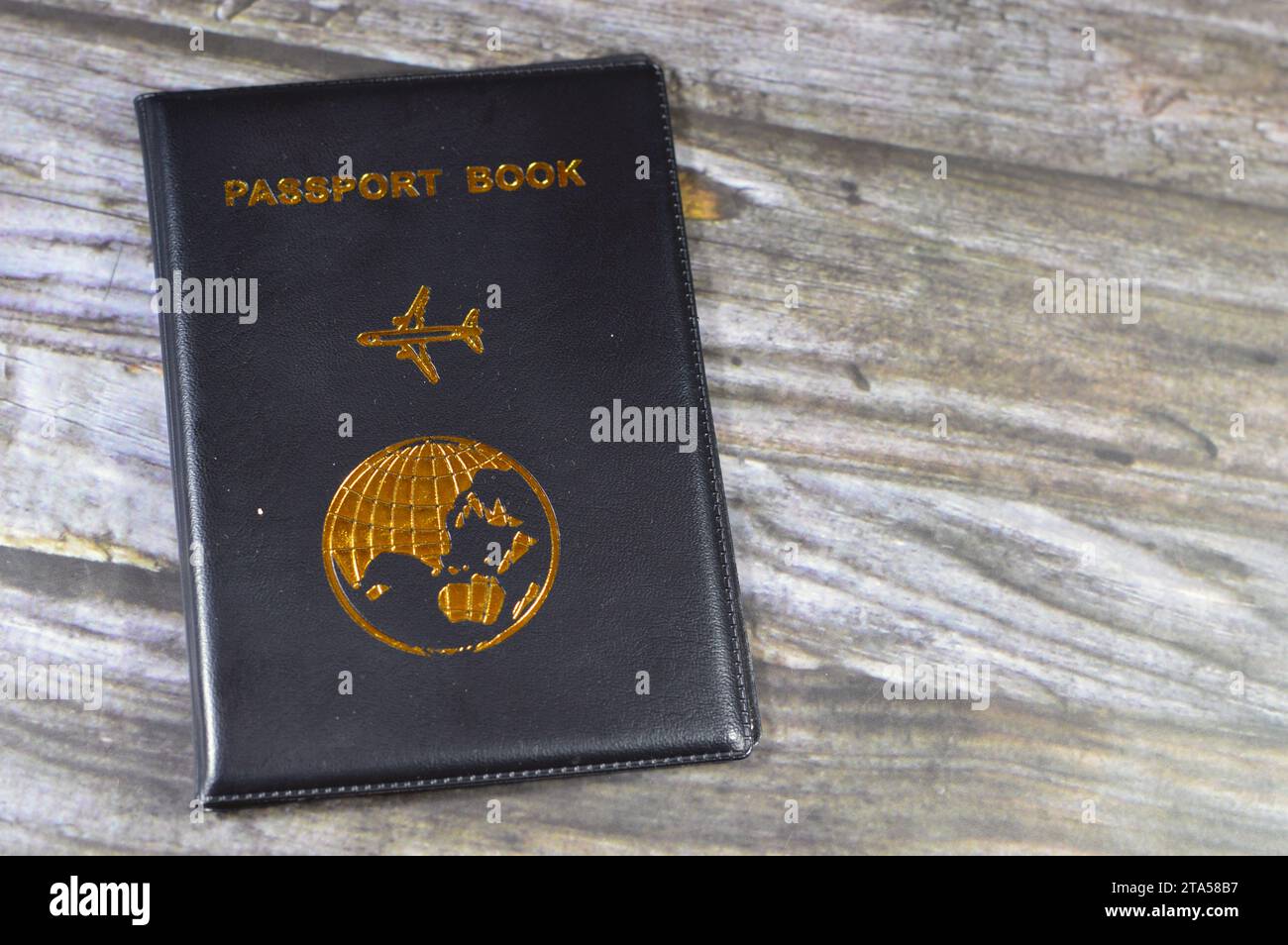 Black passport book with a plane and the globe earth on its cover ...