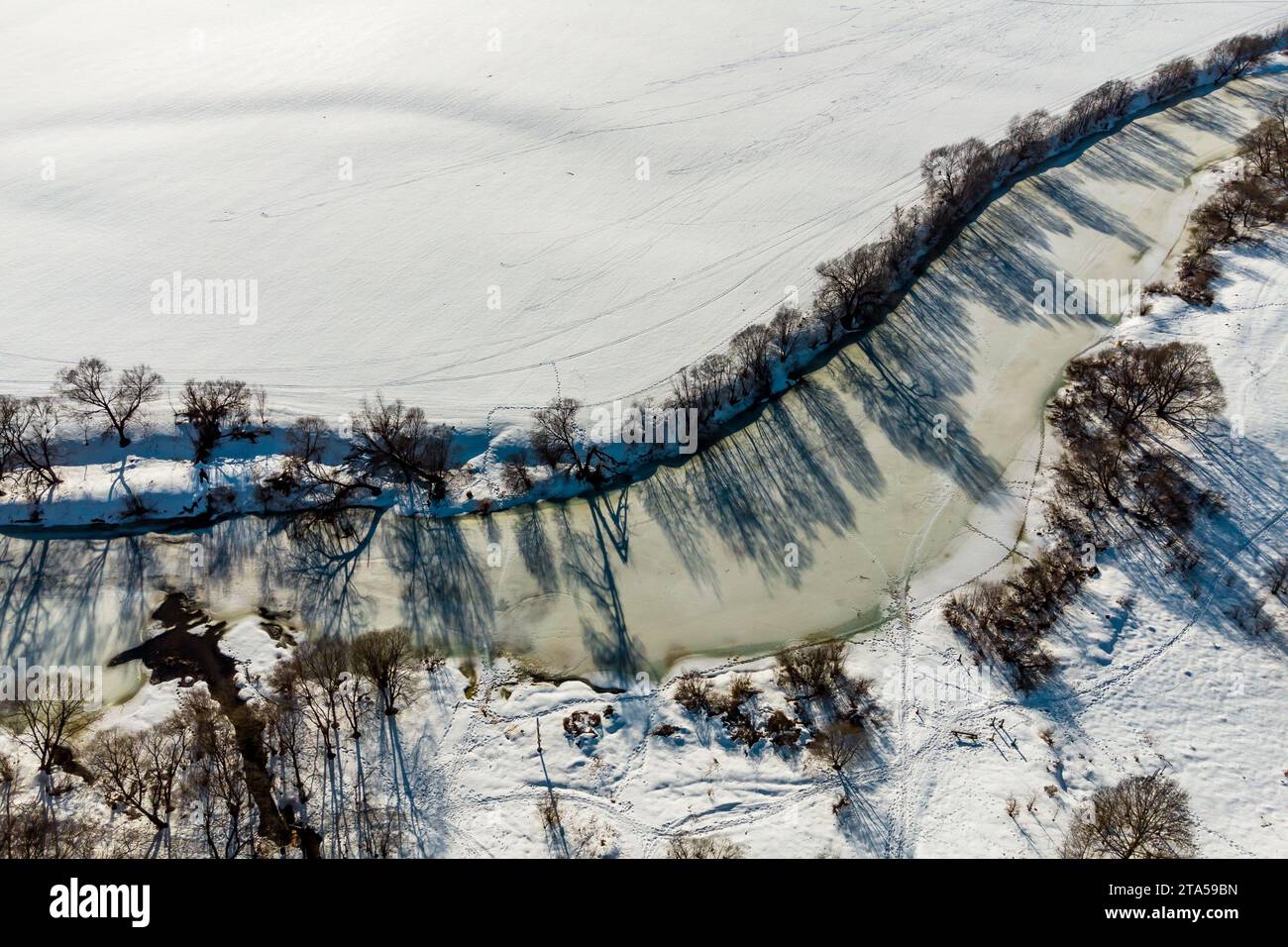 View from a high altitude of an icy river bed in the winter season ...