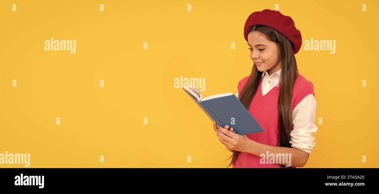 happy teen school girl in french beret reading book on yellow ...