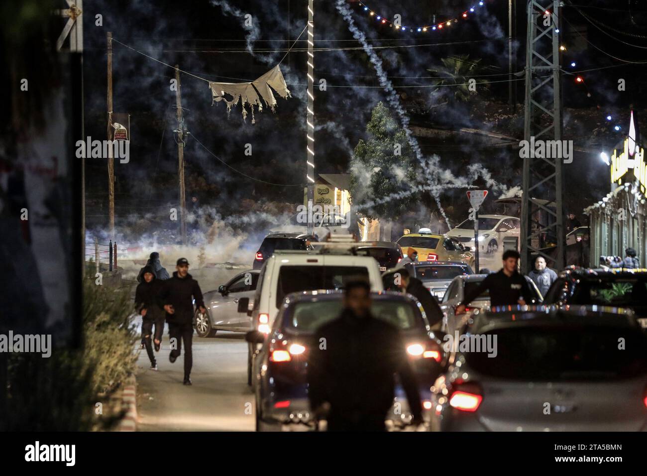 Beitunia, Palestinian Territories. 28th Nov, 2023. Palestinians run as ...