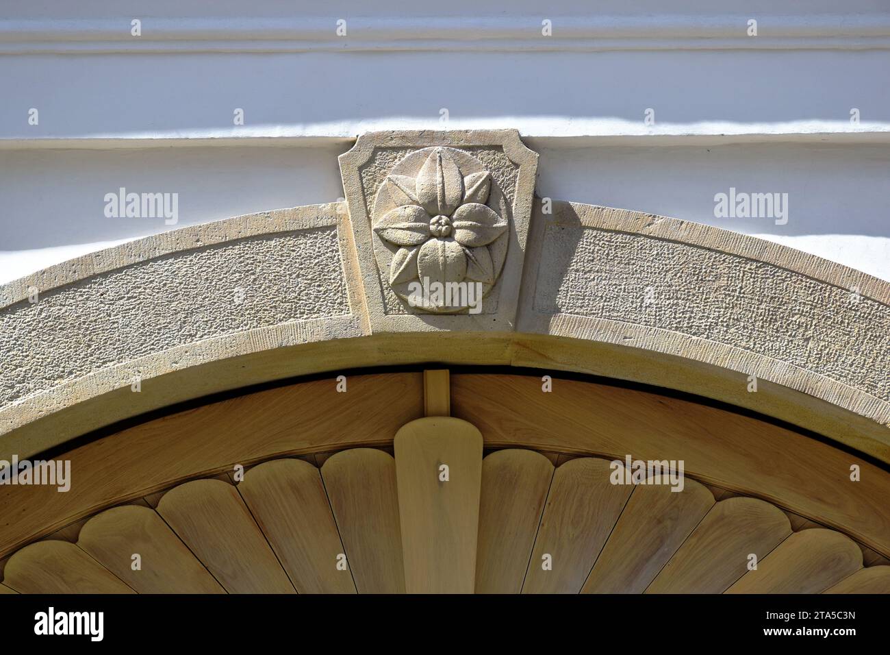 decorative stone arched beam above wood gates. Ornamental carved ...