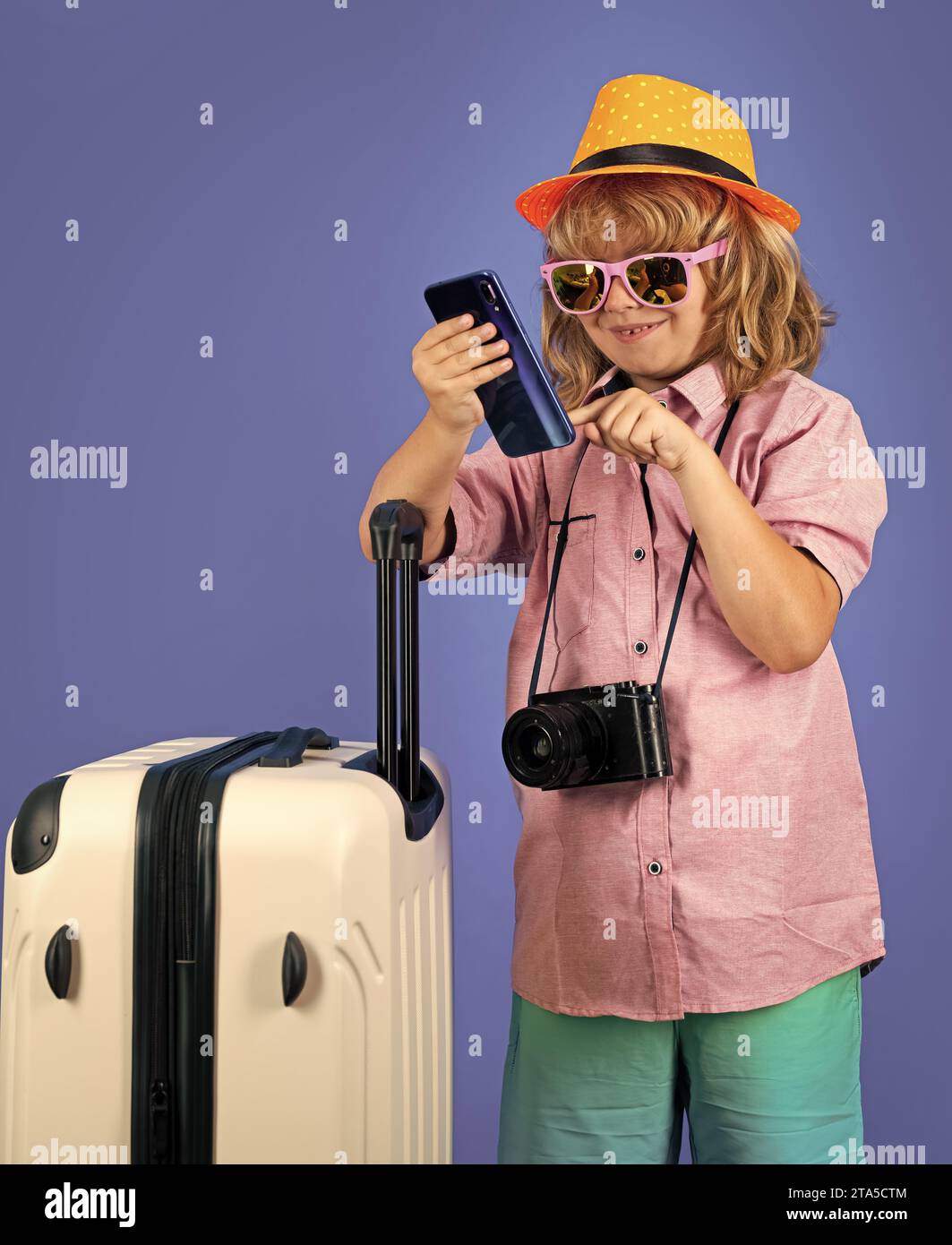 Kids travel. Happy child boy in travel hat with suitcases isolated on ...