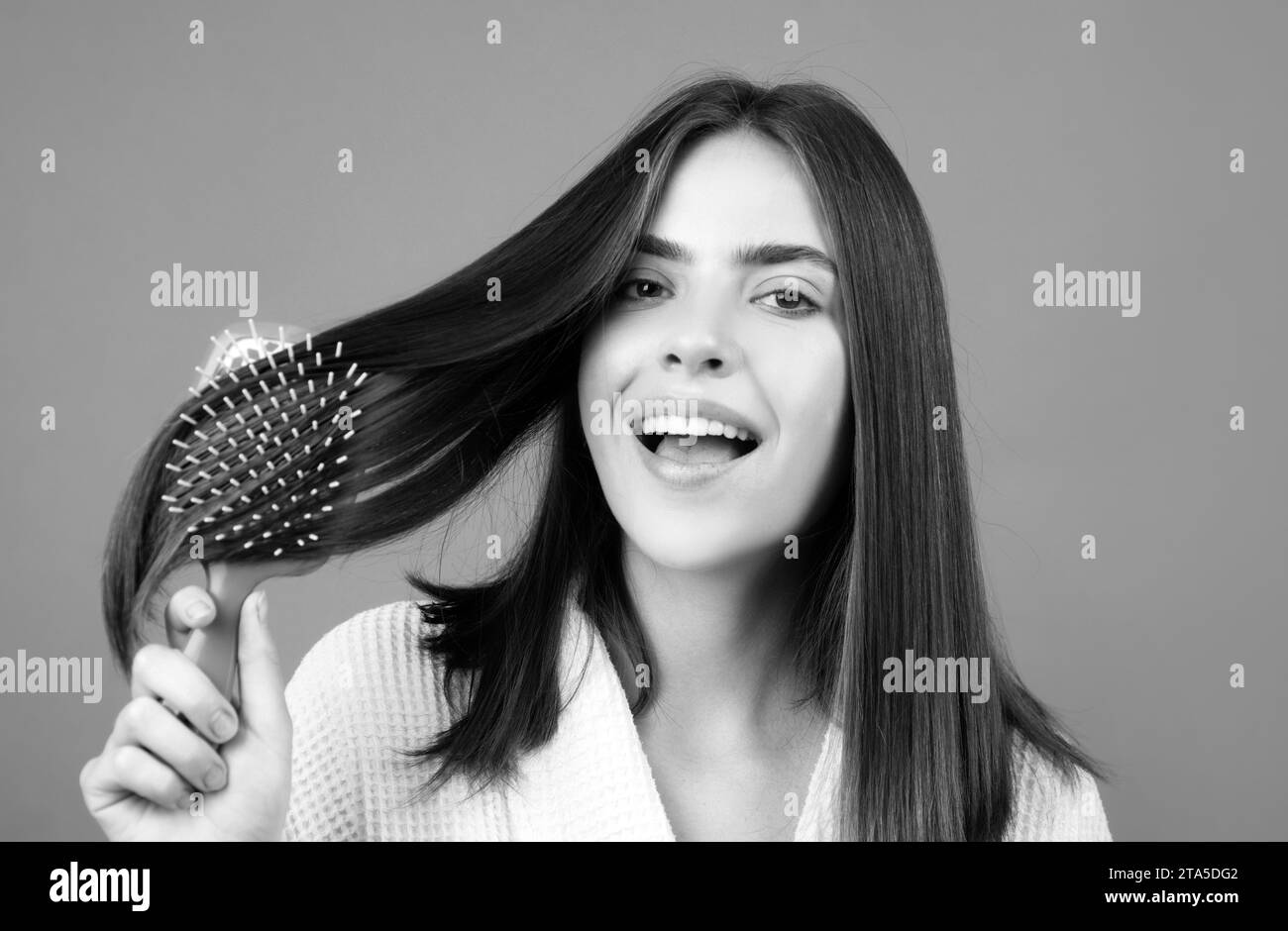 Amazed Woman Combing Hair Close Up Portrait Of Female Model With A Comb Brushing Hair Girl