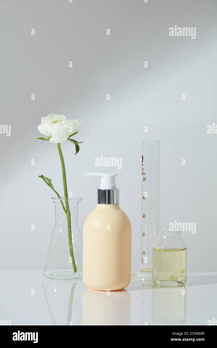 A jar of essential oil, measuring cylinder and a conical flask with ...