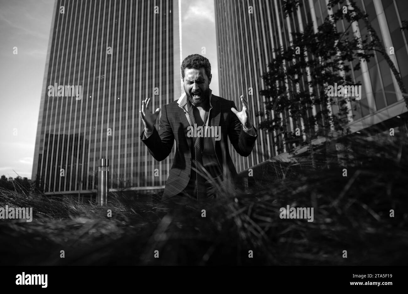 Businessman crying in depression sitting on ground street suffering ...