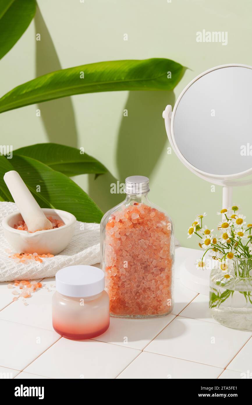 Pink himalayan salt are contained inside a transparent bottle and a ...