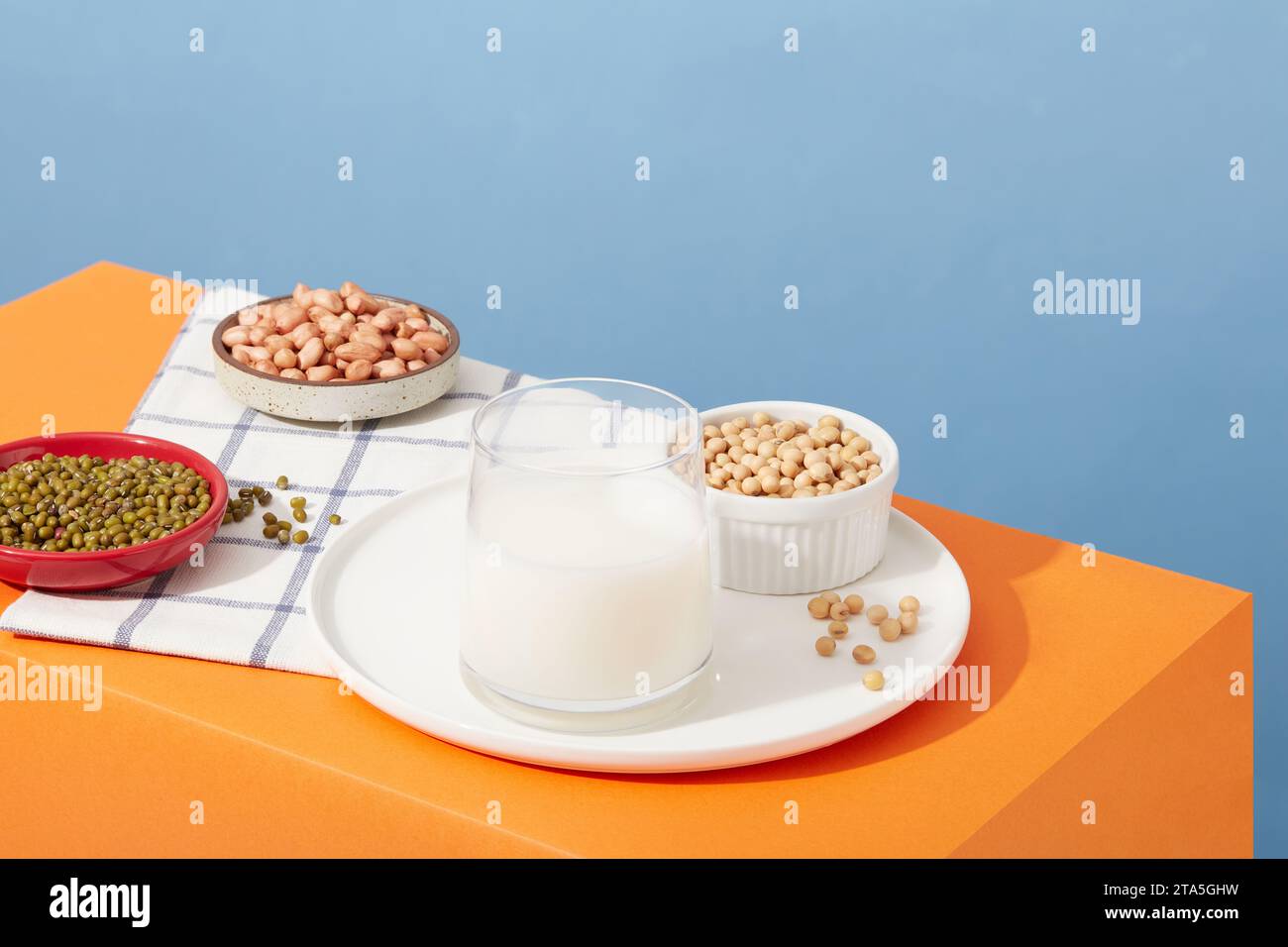 Soybeans, peanuts and green beans are contained inside dishes and a ...