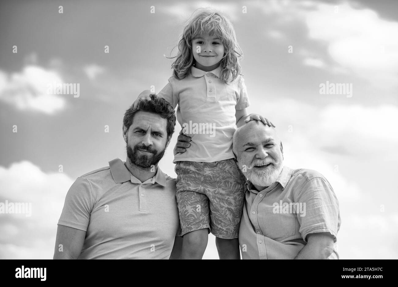 Portrait of grandfather father and funny son child outdoor on sky ...