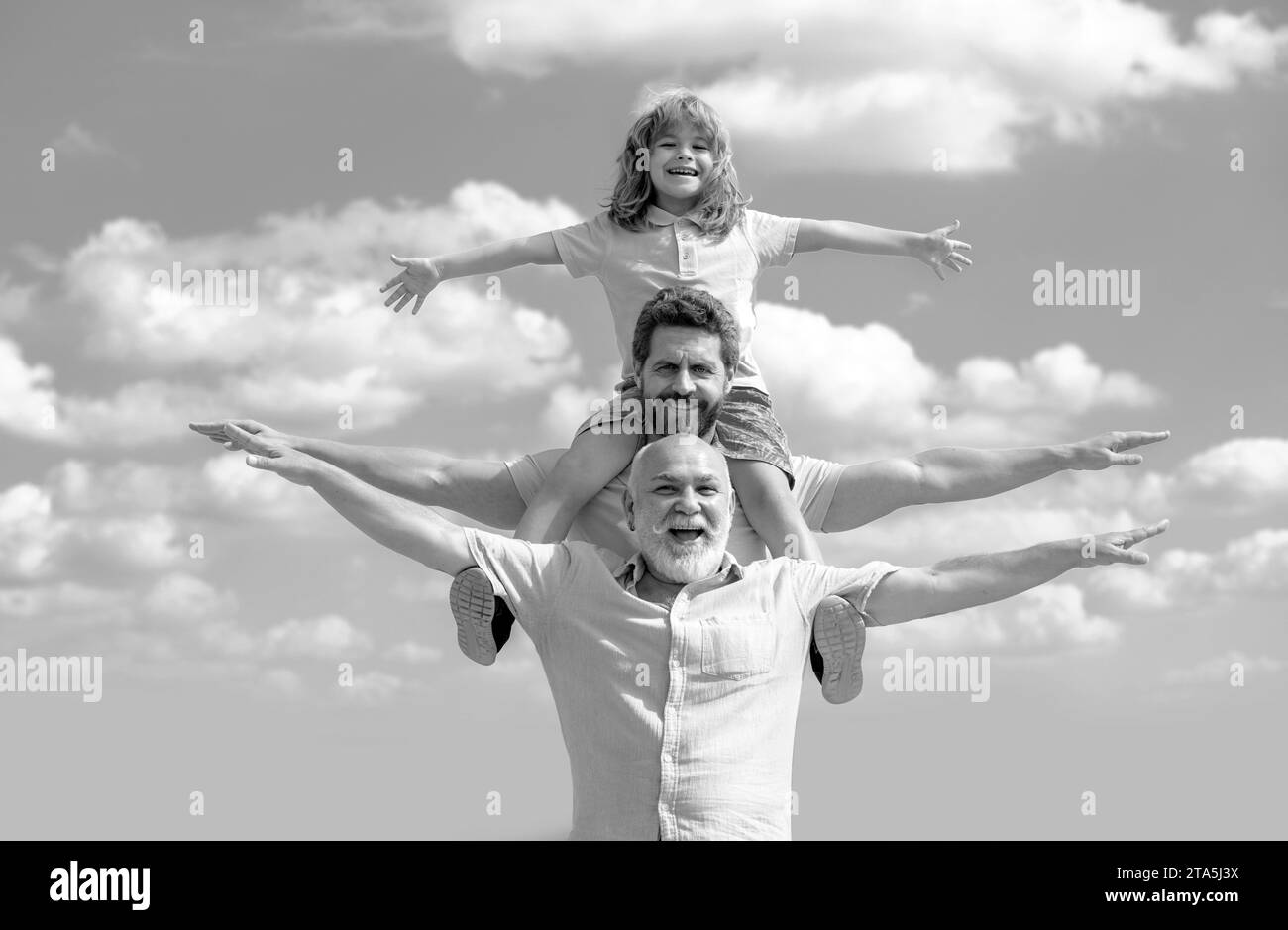 Fathers day. Father and son with grandfather raising hands or open arms ...