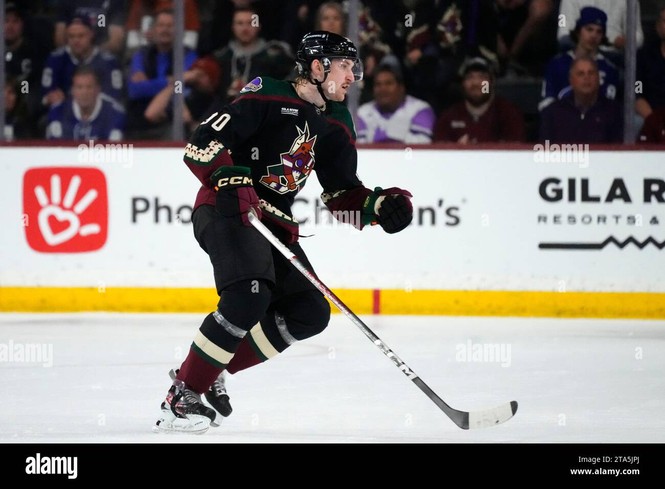 Arizona Coyotes defenseman J.J. Moser skates to the puck during the ...