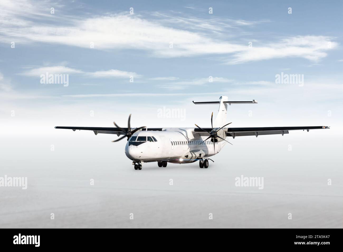 White passenger turboprop aircraft isolated on bright background with ...