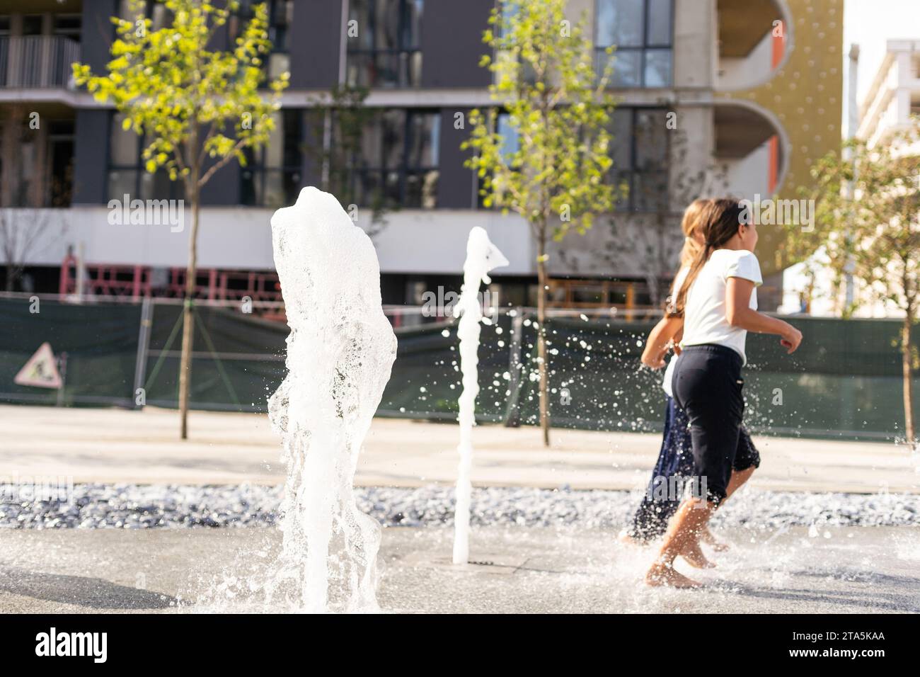 life of children in a modern city - little girl having fun with ...